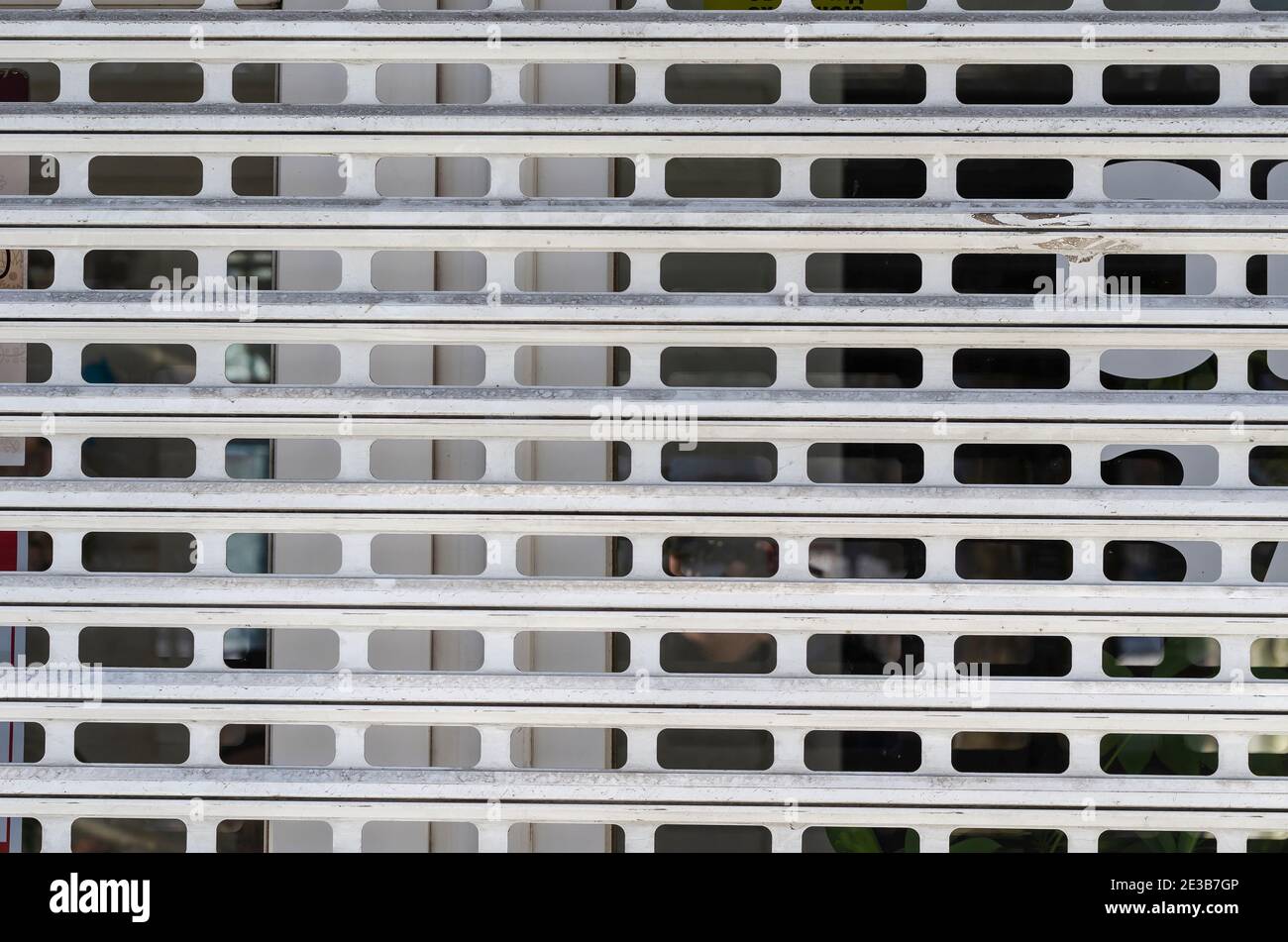 Facade of the store is closed with white roller shutters (roller blinds ...