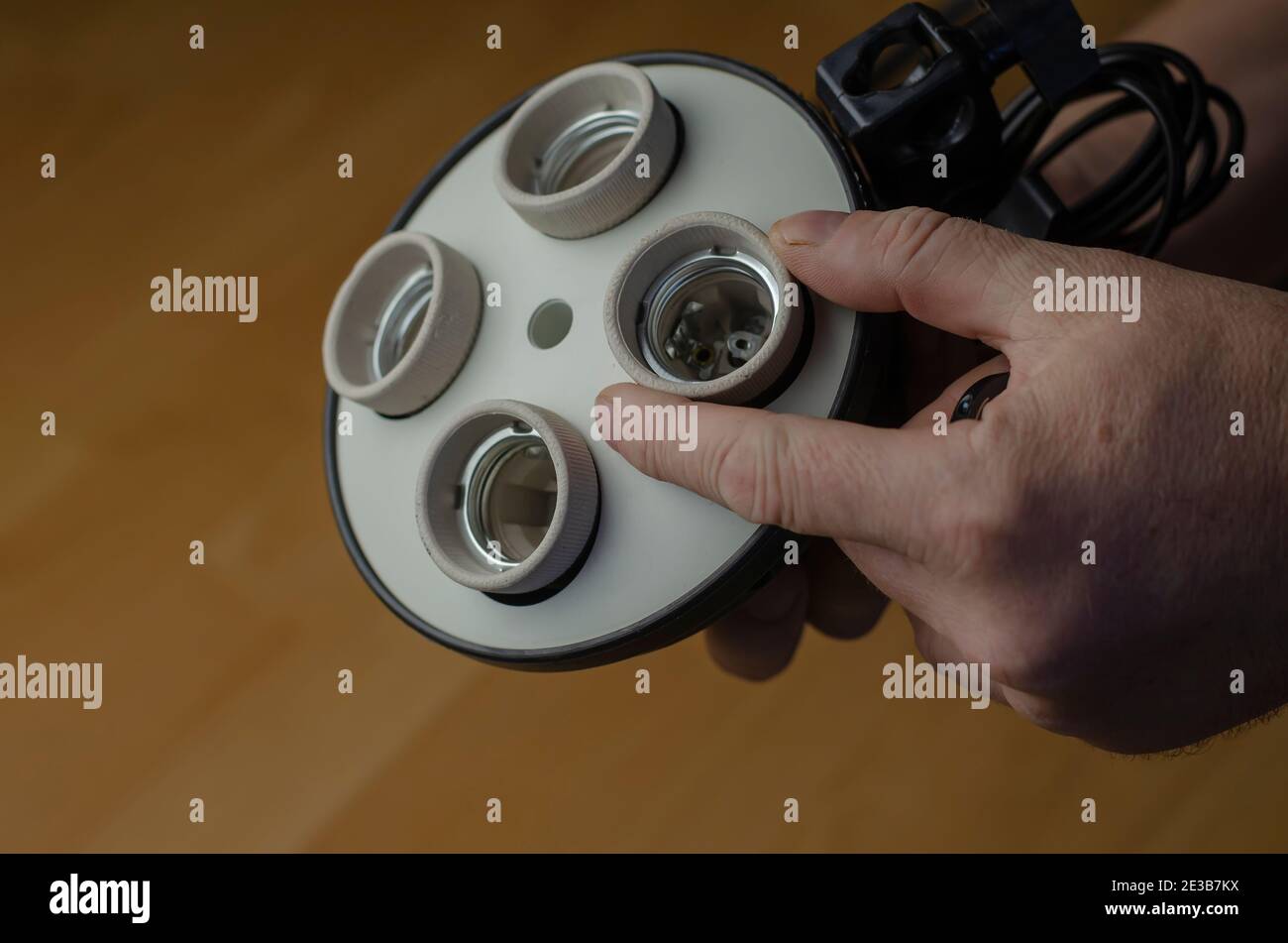 Man's Hand Holds New 4-Lamp Holder. Softbox holder, photo equipment ...