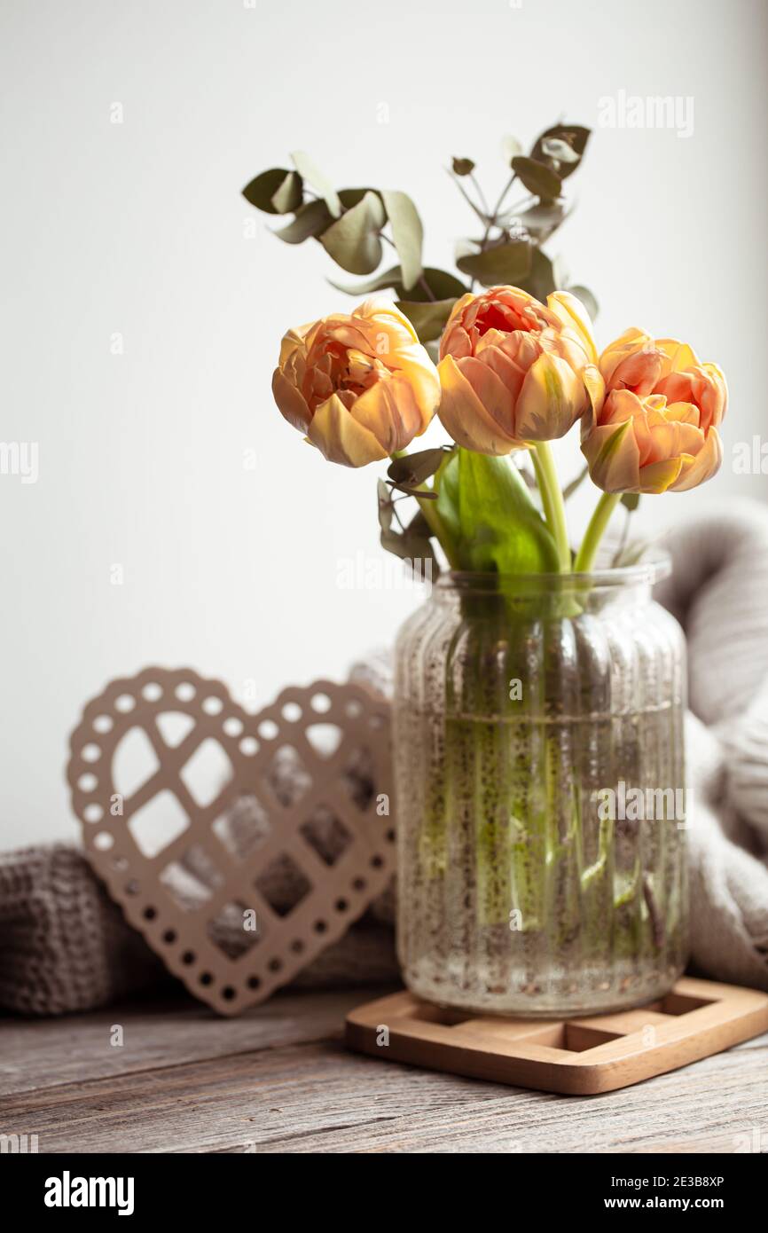A festive still life with a flower arrangement in a vase and decorative ...