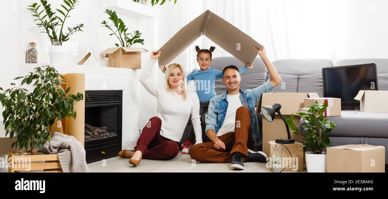 concept housing a young family. Mother father and child in new house ...
