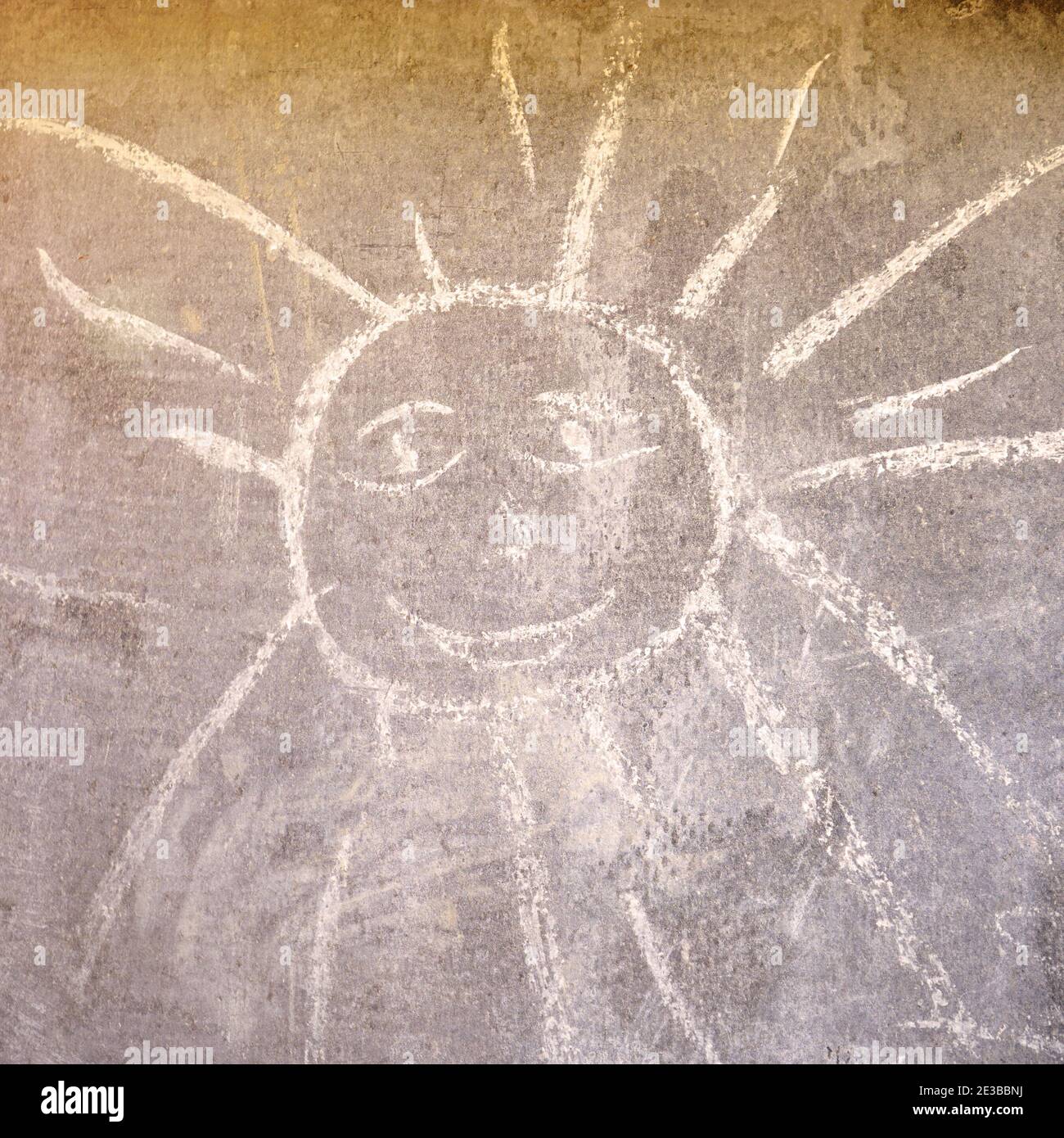 A smiling sun drawn in chalk on a gray wall. Drawing with chalk Stock ...