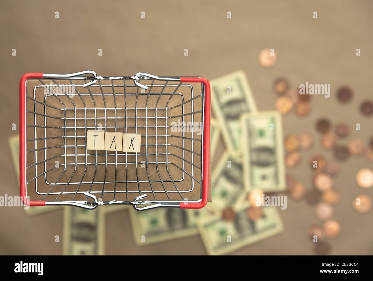 Tax written with wooden cubes top view in shopping basket with money ...