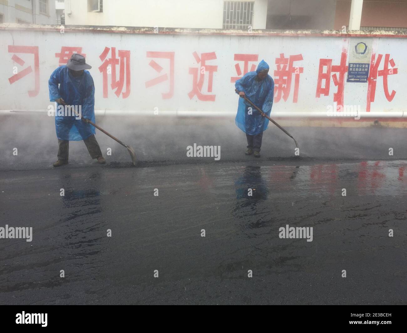 Workers are paving the road with asphalt Stock Photo - Alamy
