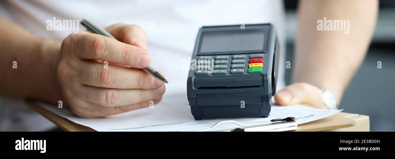 Male hand sign order receipt close up and pay by terminal Stock Photo ...
