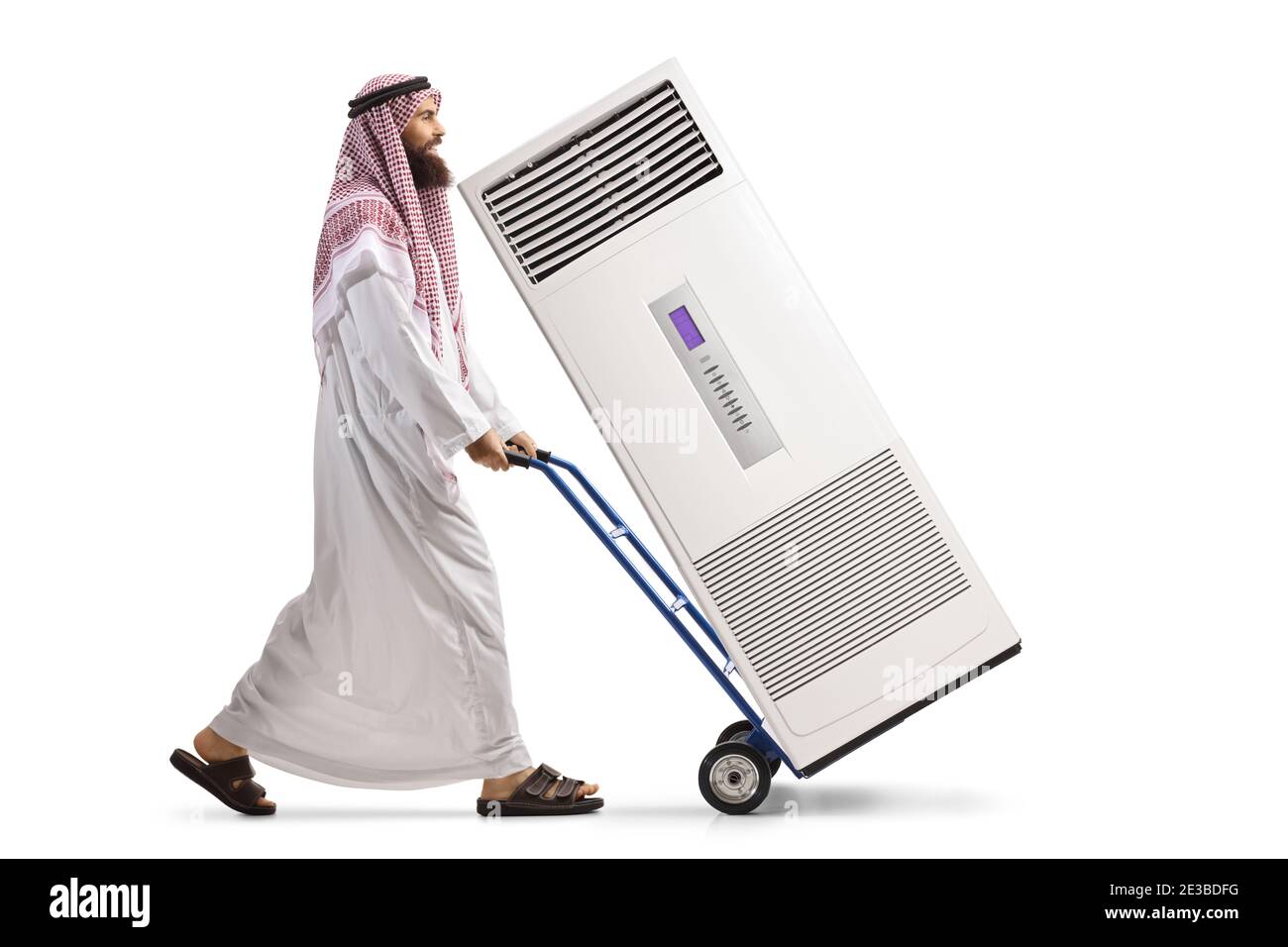Full length profile shot of a saudi arab man pushing a hand truck with ...