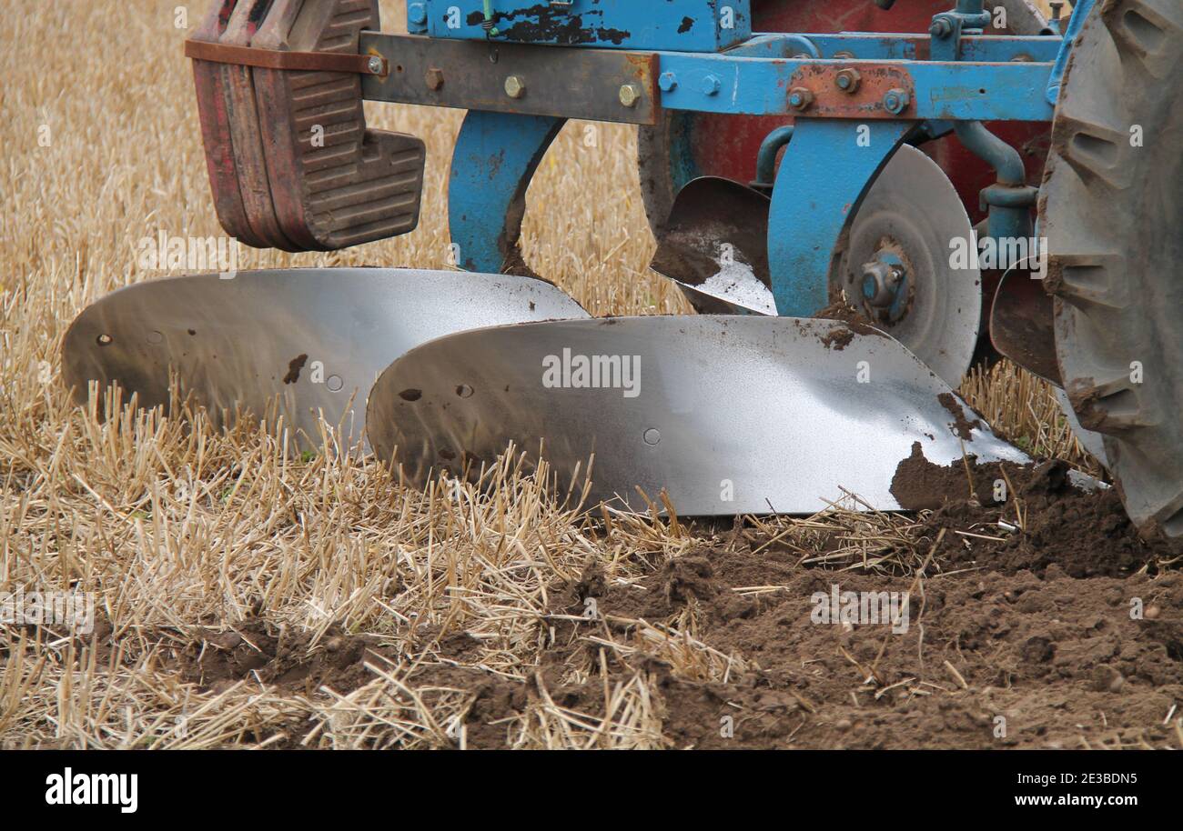 An Old Plough Cutting a Furrow in a Farmers Field Stock Photo - Alamy