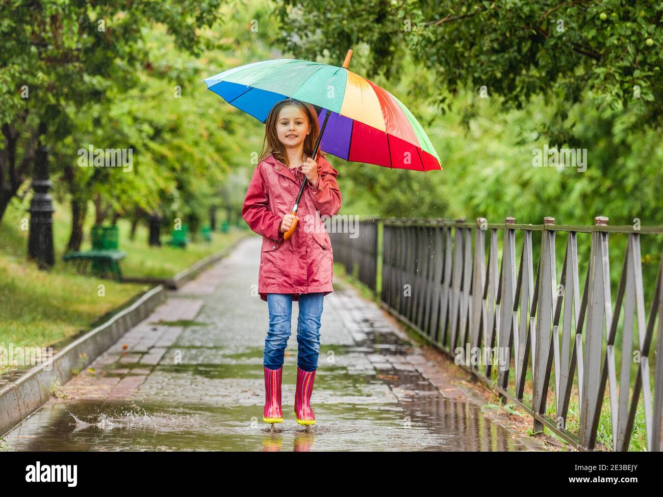 Kid child jumping puddle water splash hi-res stock photography and ...