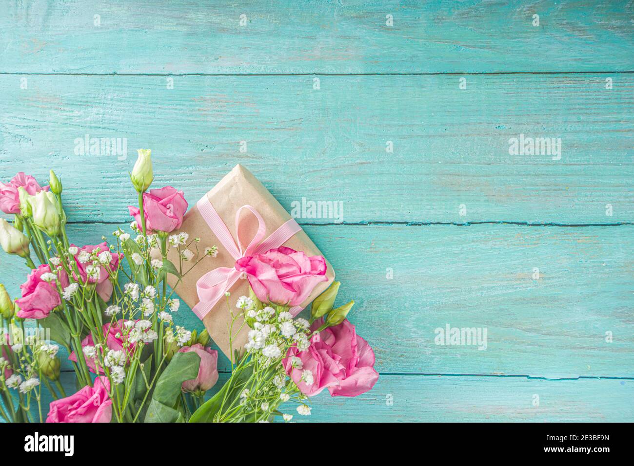 Beautiful spring flowers on light blue wooden background. Festive ...