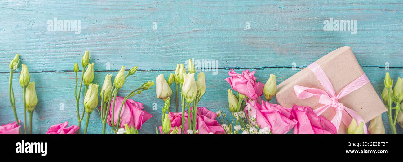 Beautiful spring flowers on light blue wooden background. Festive ...