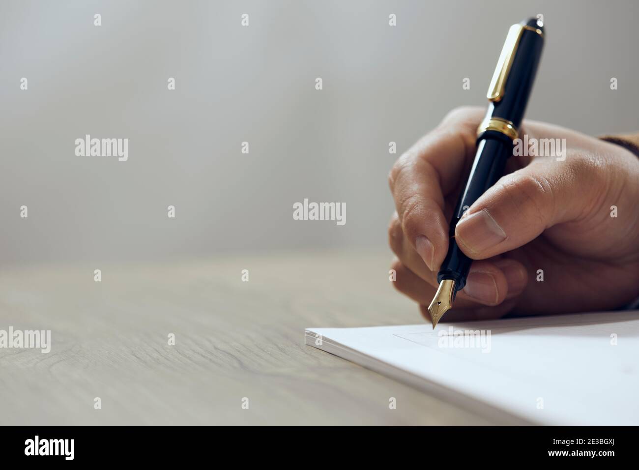 Man writing on paper Stock Photo - Alamy
