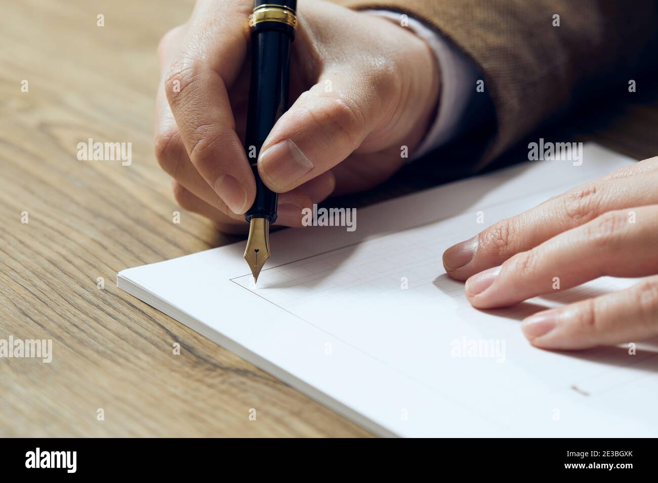 Man writing on paper Stock Photo - Alamy