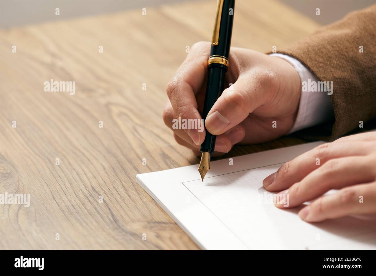 Man writing on paper Stock Photo - Alamy
