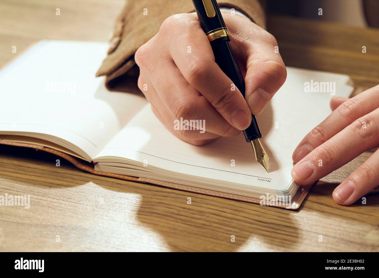 Man writing on paper Stock Photo - Alamy