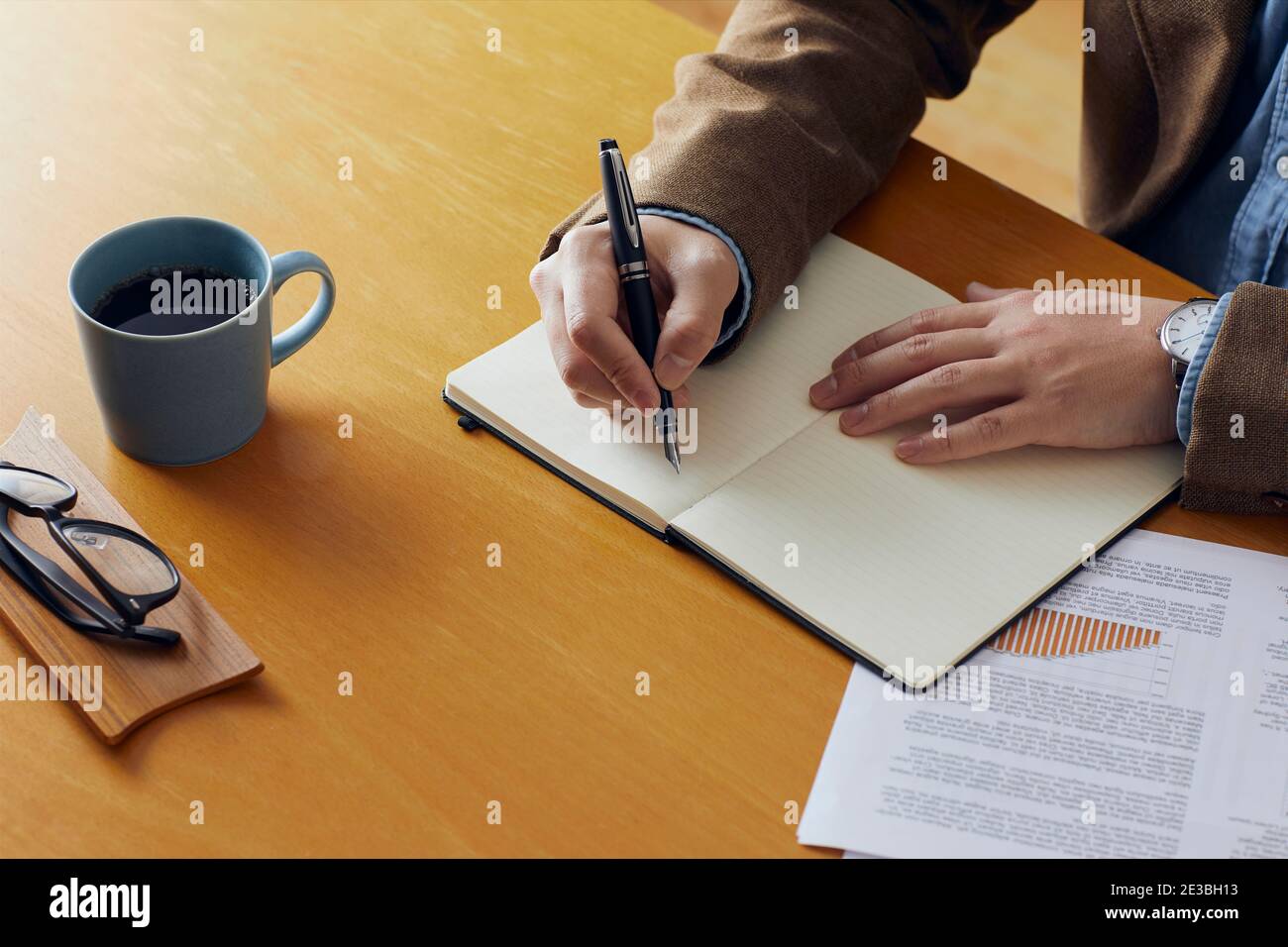 Man writing on paper Stock Photo - Alamy