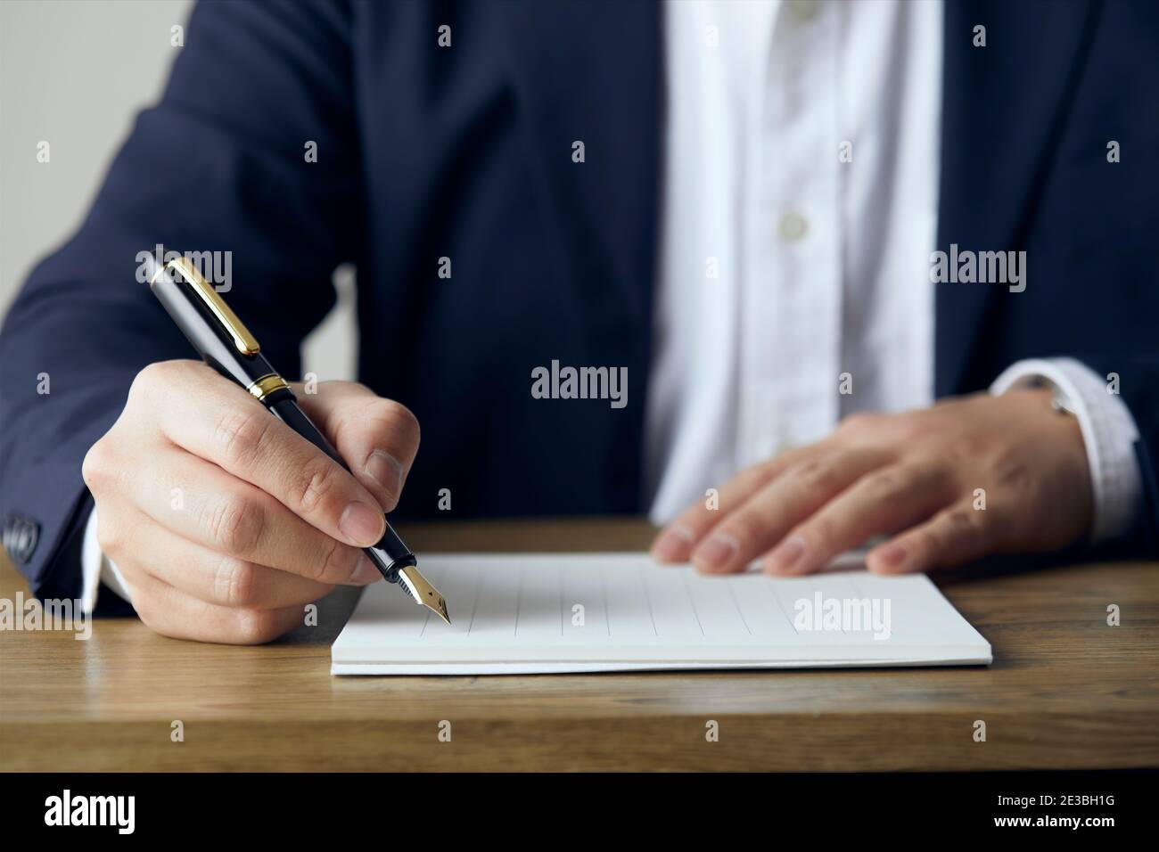 Man writing on paper Stock Photo - Alamy