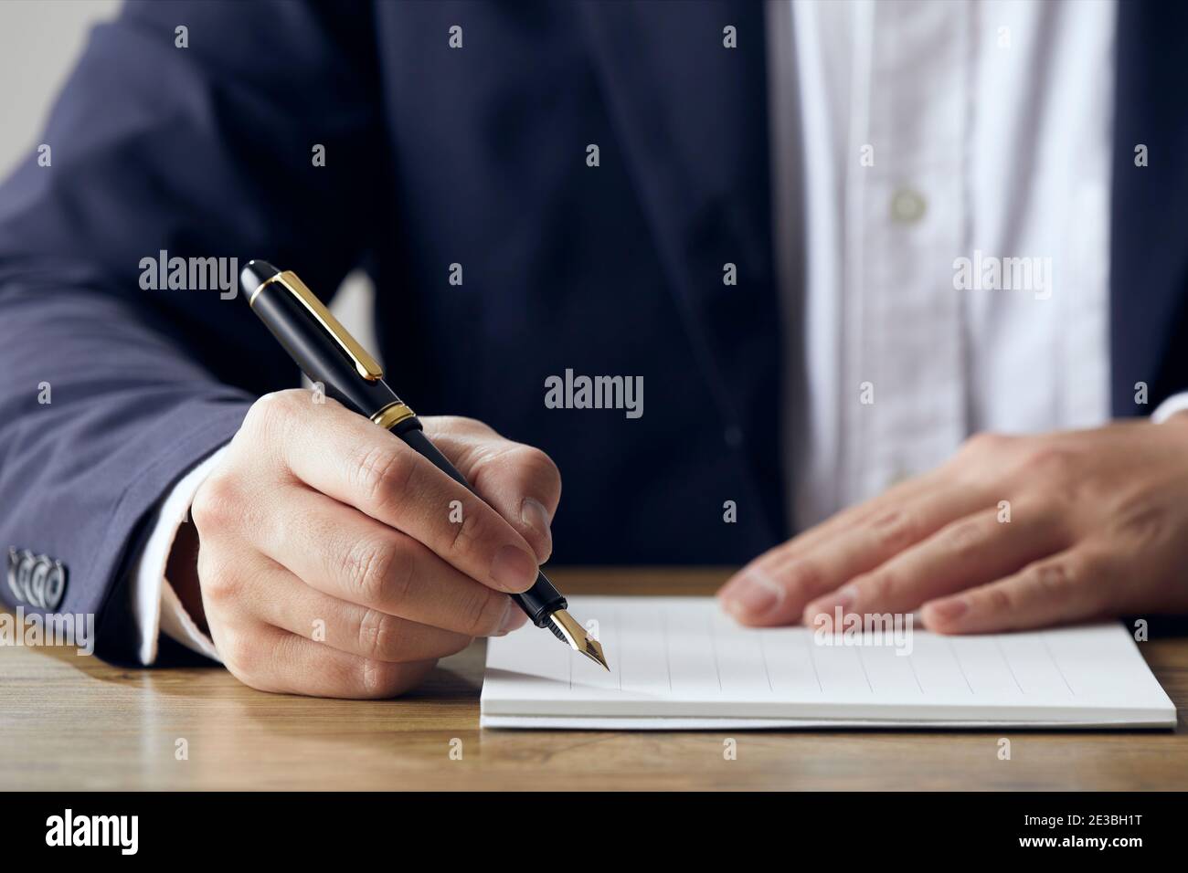 Man writing on paper Stock Photo - Alamy