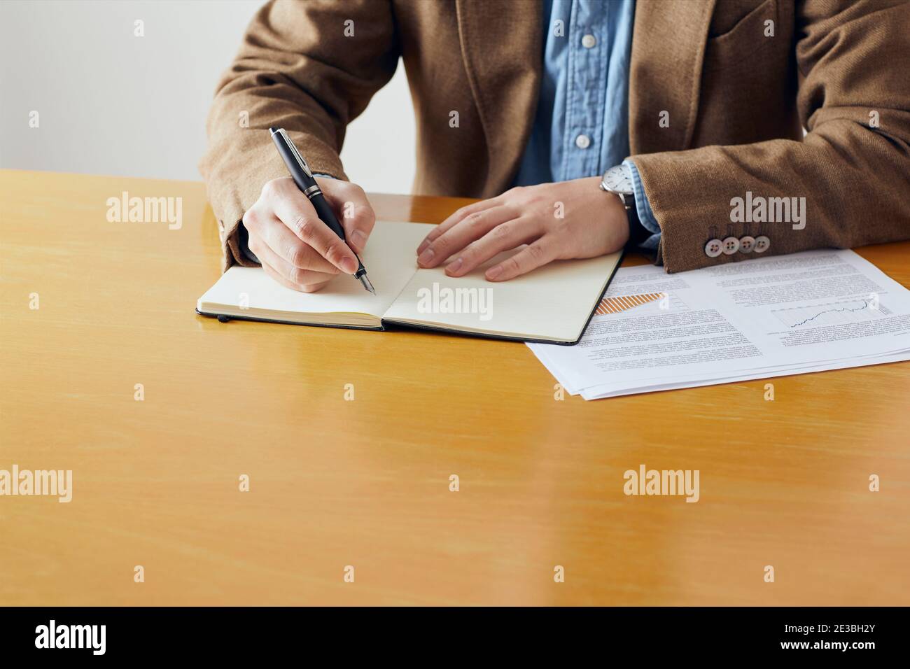 Man writing on paper Stock Photo - Alamy