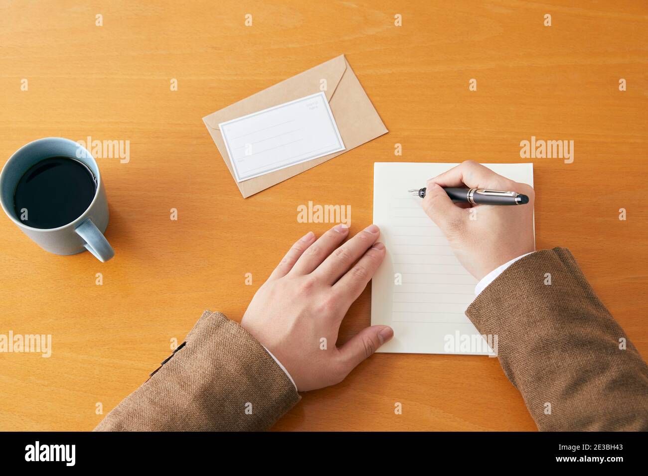 Man writing on paper Stock Photo - Alamy