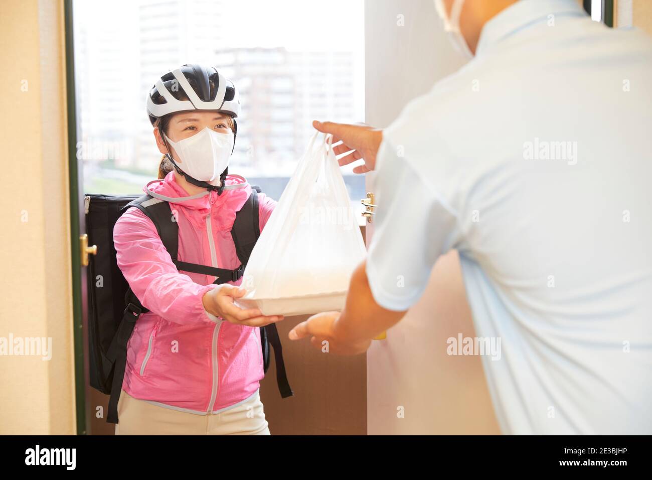 Receiving food delivery at front door hi-res stock photography and ...