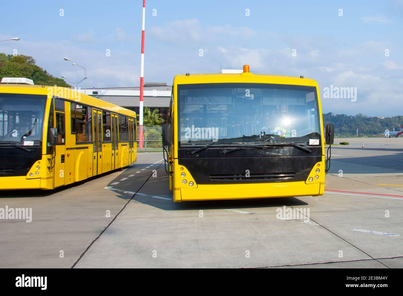 Shuttle yellow buses to transport passengers from the terminal building ...