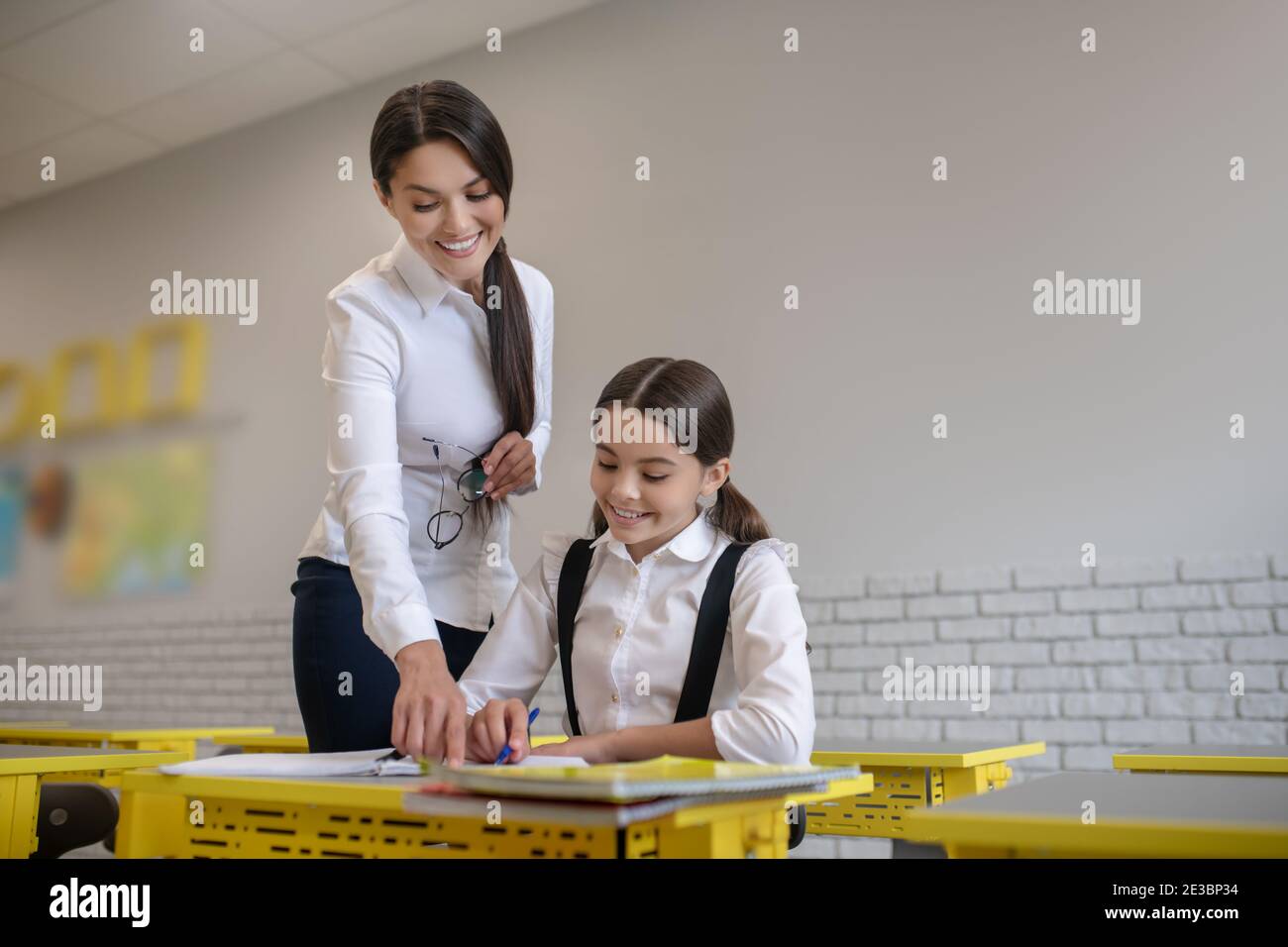 Young schoolgirl with teacher hi-res stock photography and images - Alamy