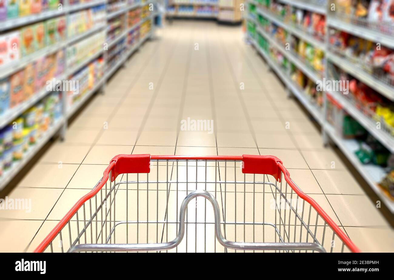 Abstract blur in supermarket with shopping cart. Grocery shopping ...