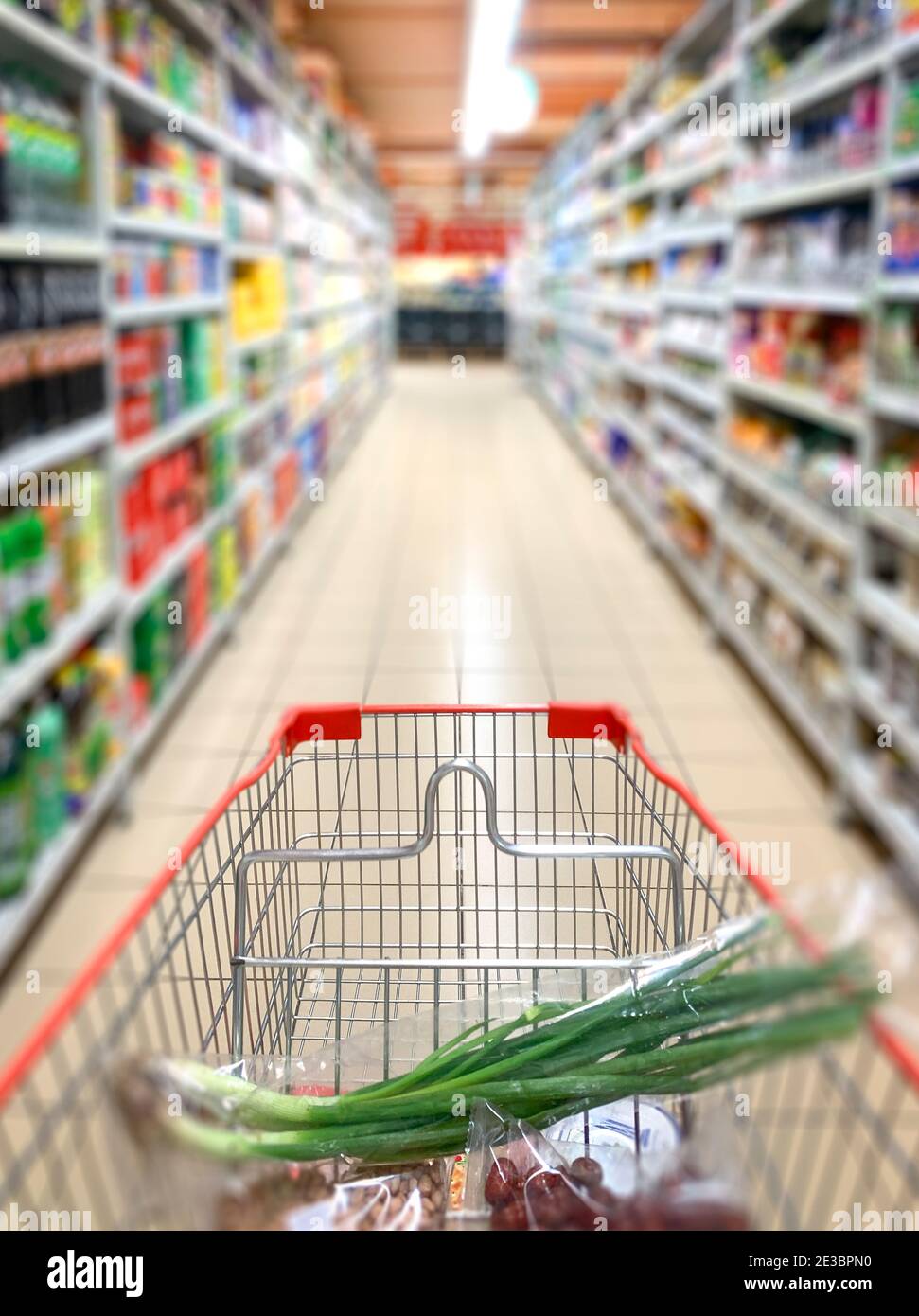 Abstract blur in supermarket with shopping cart. Grocery shopping ...