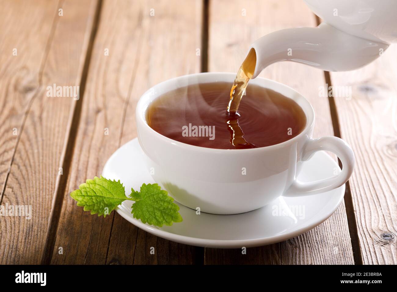 tea pouring from teapot into a cup Stock Photo - Alamy