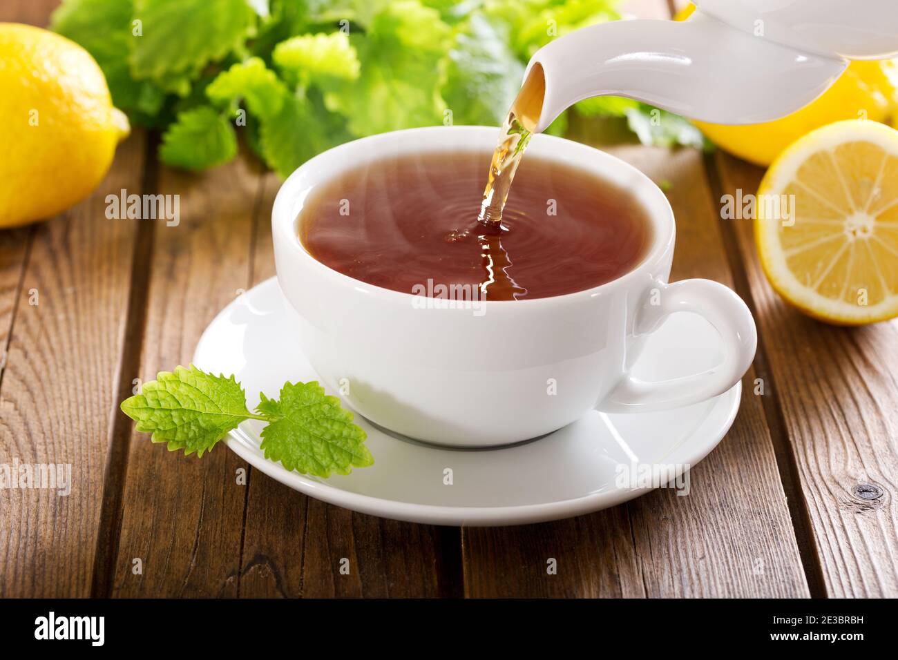 tea pouring from teapot into a cup Stock Photo - Alamy
