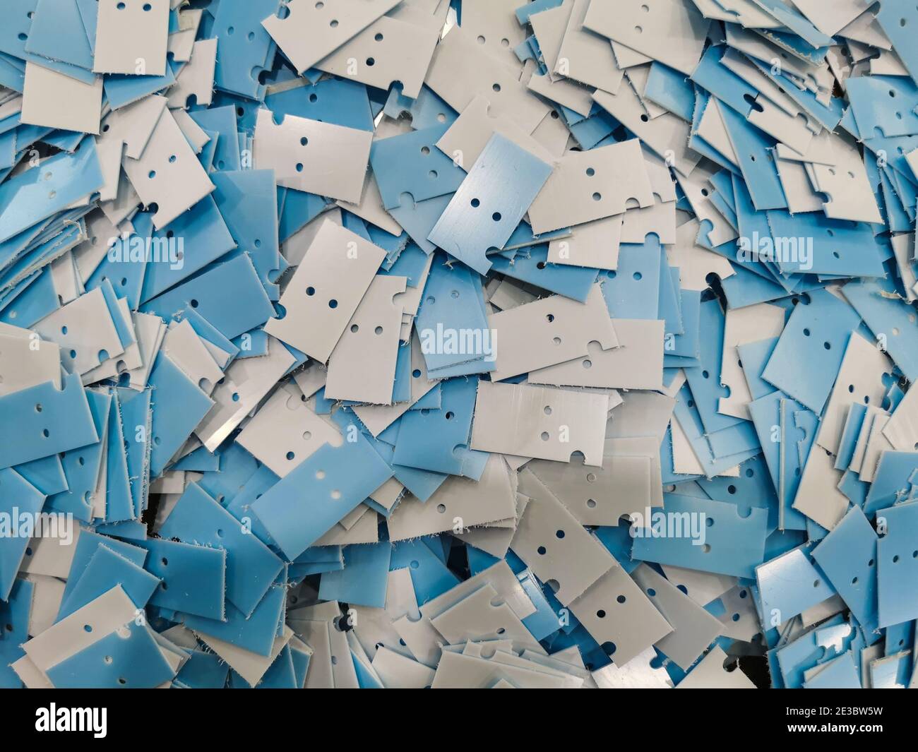 Bunch of white and blue plastic manufactured bits Stock Photo - Alamy