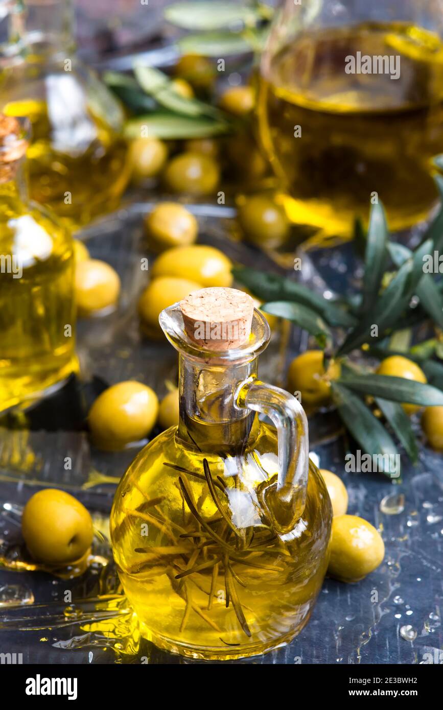Extra virgin olive oils. Olive oil flavored with rosemary in a vintage ...
