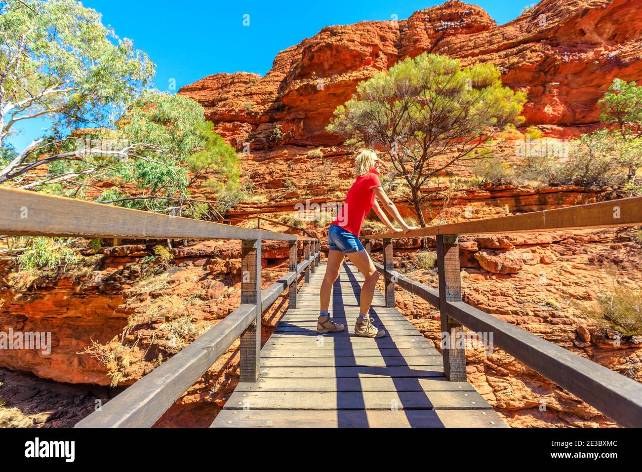 Caucasian tourist woman at Kings Canyon Rim Walk with foot bridge over ...