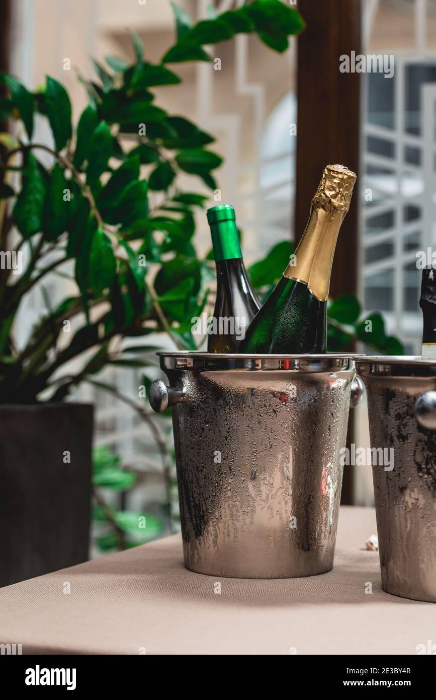 Bottle of champagne in bucket in a restaurant Stock Photo - Alamy