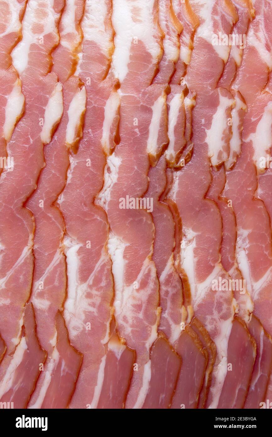 Close-up, background of raw bacon, a popular meat product, ingredient ...