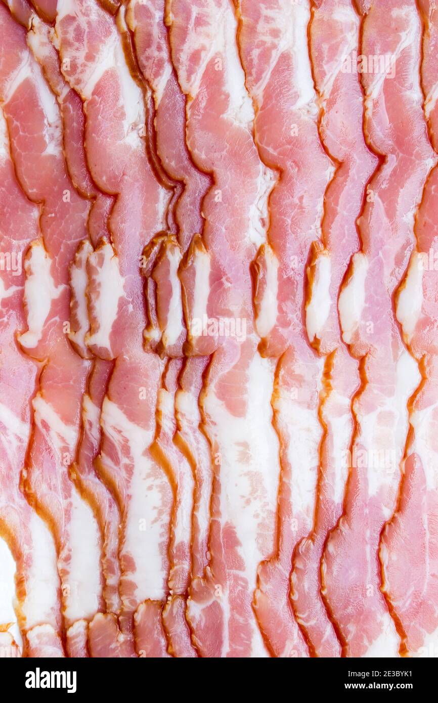 Close-up, background of raw bacon, a popular meat product, ingredient ...