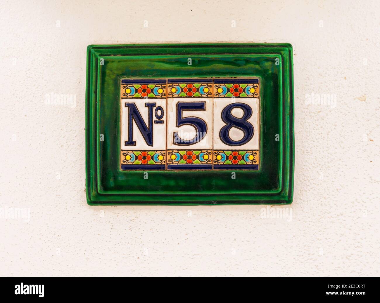 Decorative ceramic house number 58 tile on the wall, characteristic ...