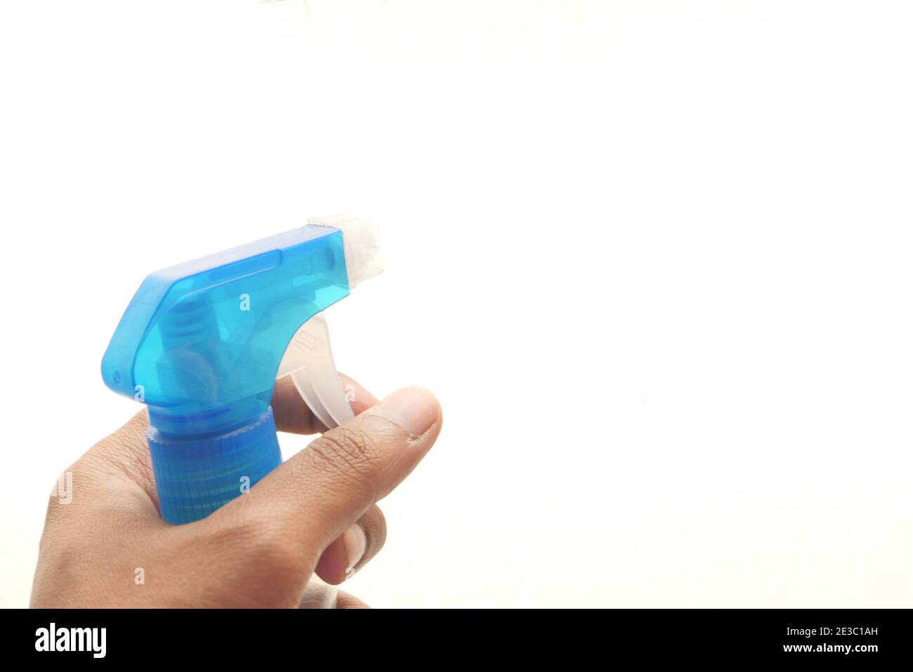 hand holding spray bottle isolated in white Stock Photo - Alamy