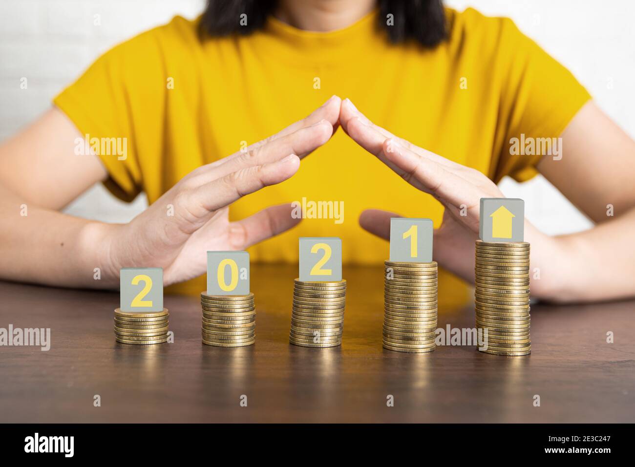 Protect money in 2021 concept, woman save stack of money coin to growth ...