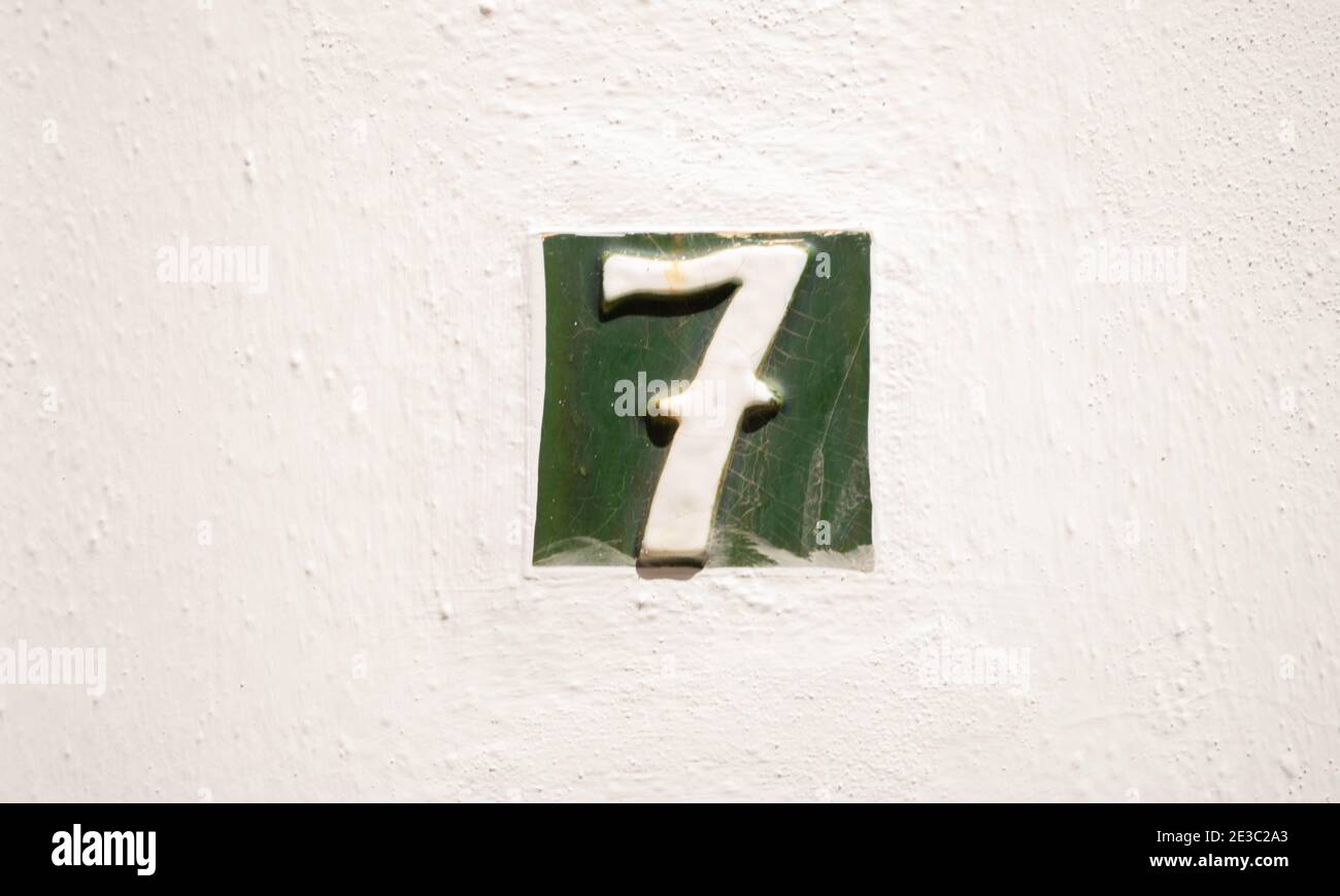 Decorative ceramic house number 7 tile on the wall, characteristic ...