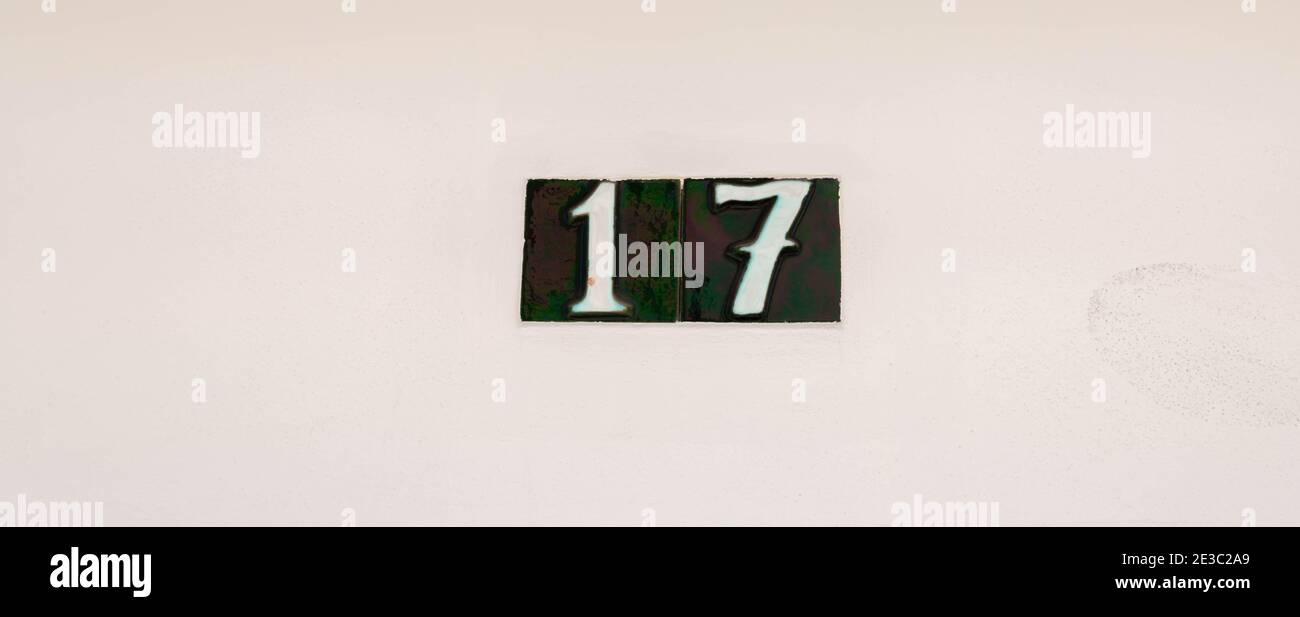 Decorative ceramic house number 17 tile on the wall, characteristic ...