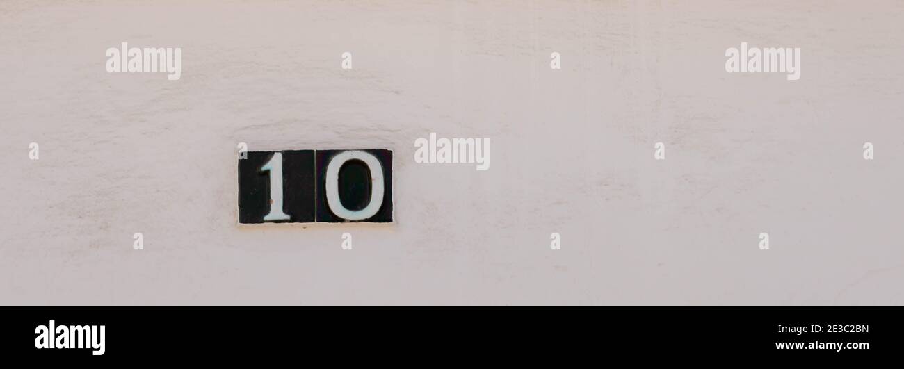 Decorative ceramic house number 10 tile on the wall, characteristic ...