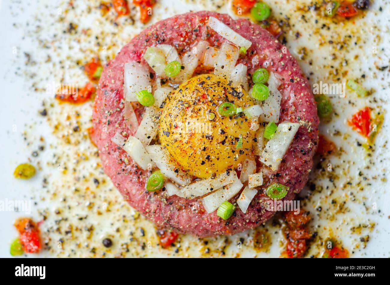 Beef steak tartare with raw egg yolk and onion with tomato, appetizer ...
