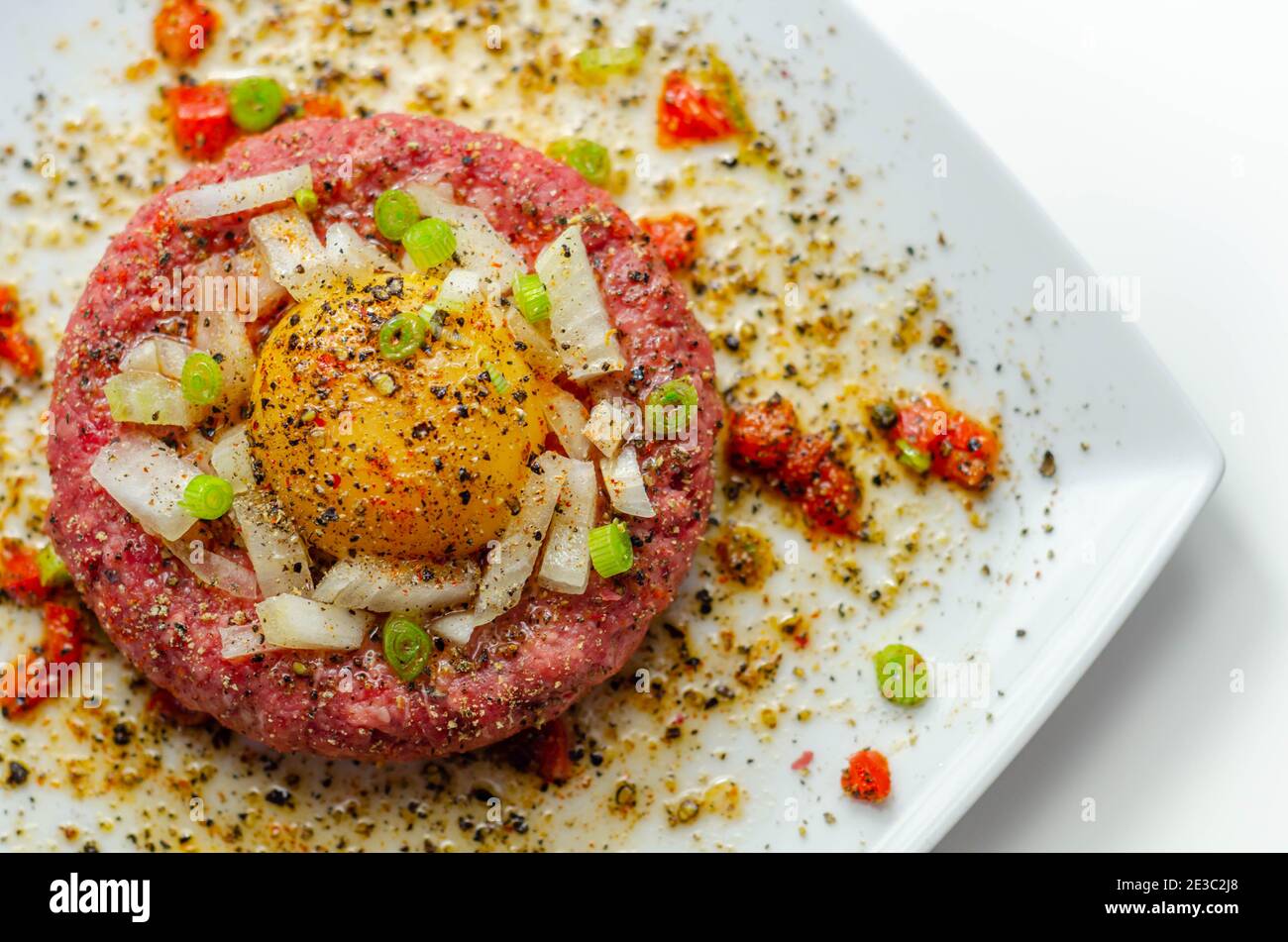 Beef steak tartare with raw egg yolk and onion with tomato, appetizer ...