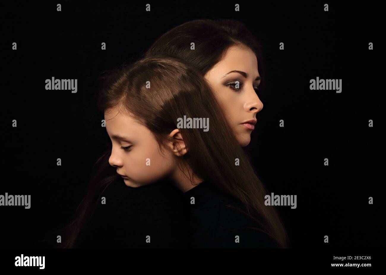 Sad serious thinking daughter hugging her unhappy mother with pensive ...
