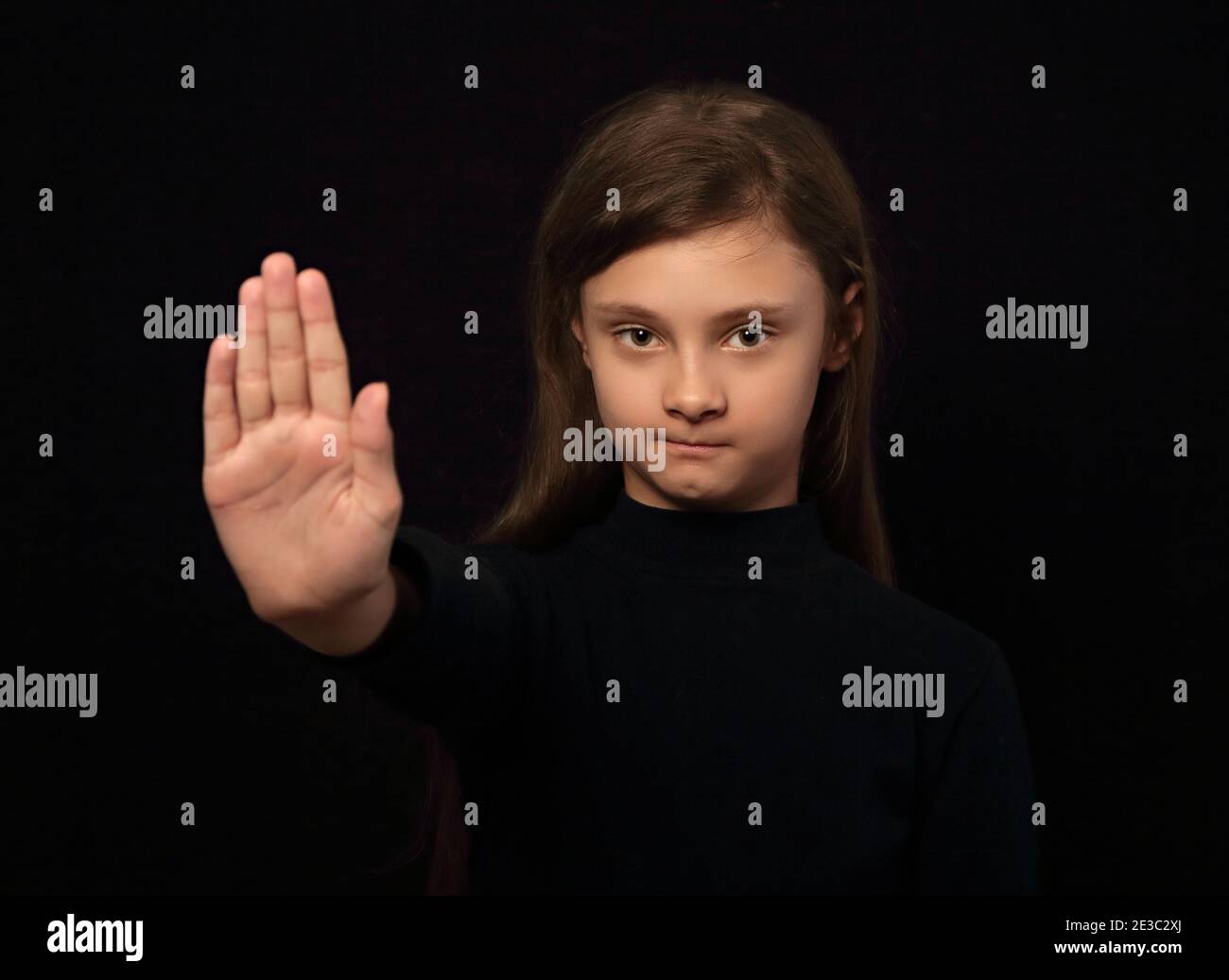 Angry serious kid girl showing two palms of hands signaling to stop ...