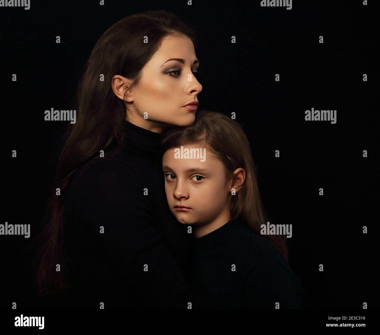 Sad serious thinking daughter hugging her unhappy mother with pensive ...