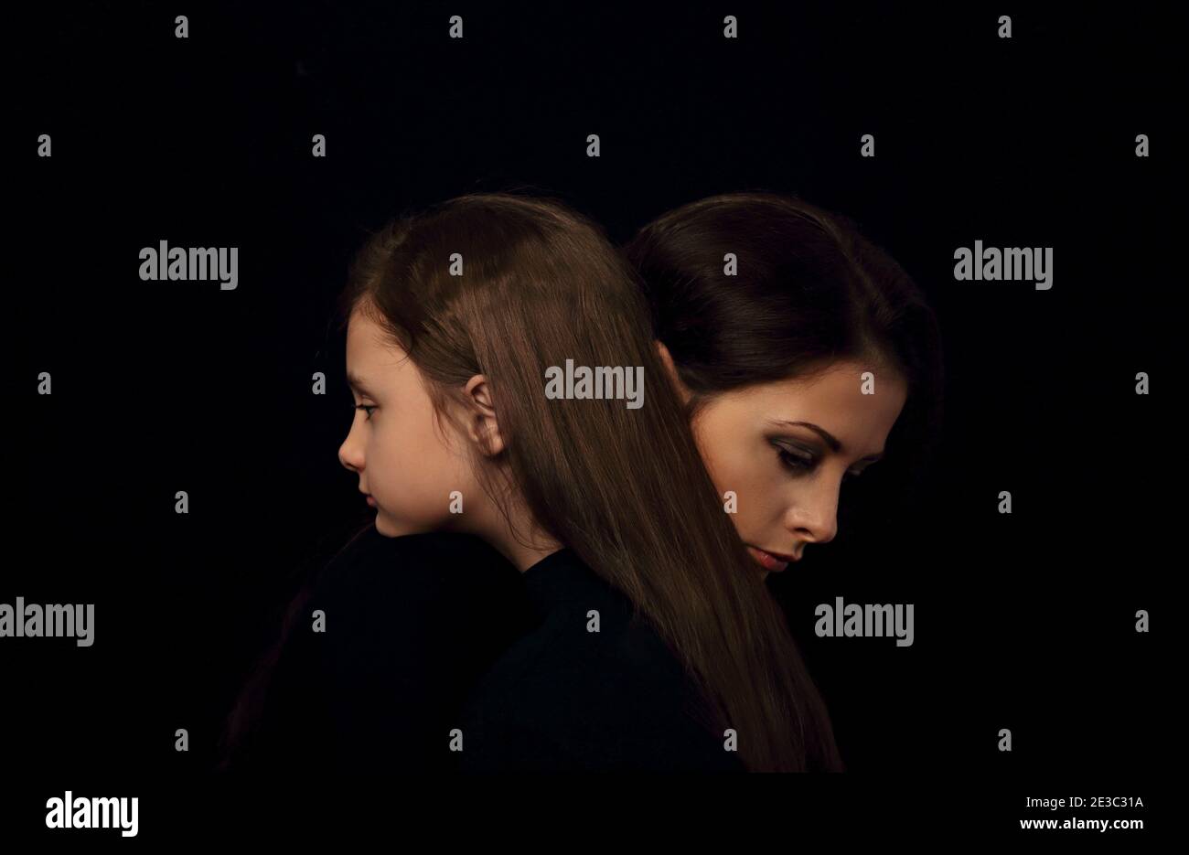 Sad serious thinking daughter hugging her unhappy mother with pensive ...