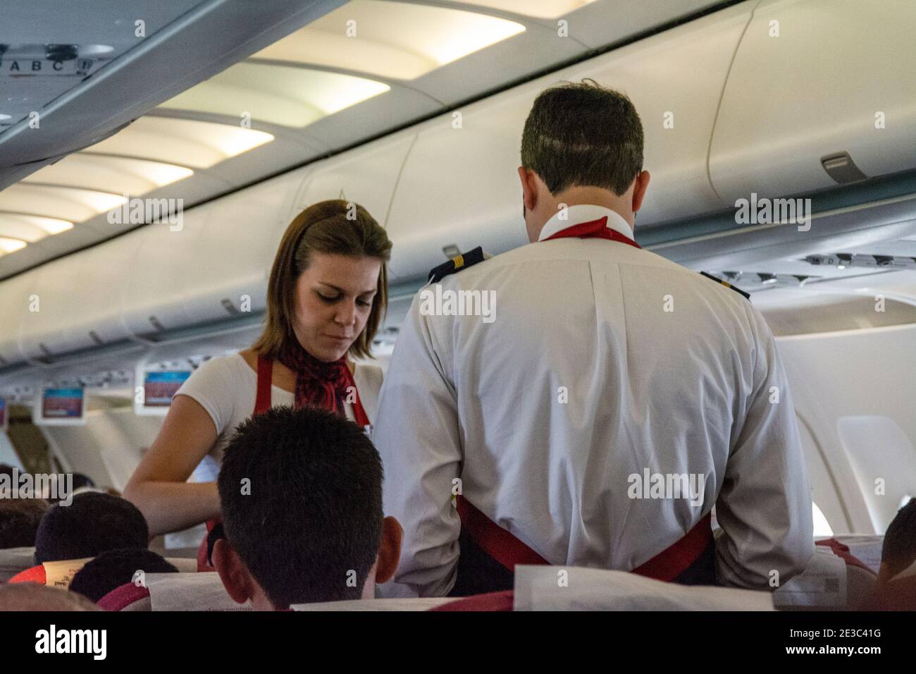 Cabin crew serving refreshments in economy class on an Airbus 320 - TAM ...