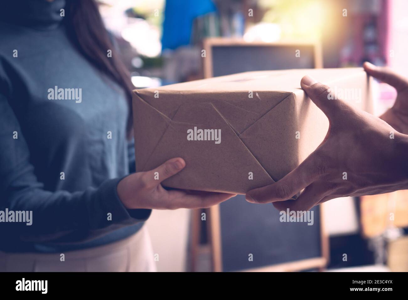 close up hand of customer woman get box parcel from delivery man Stock ...