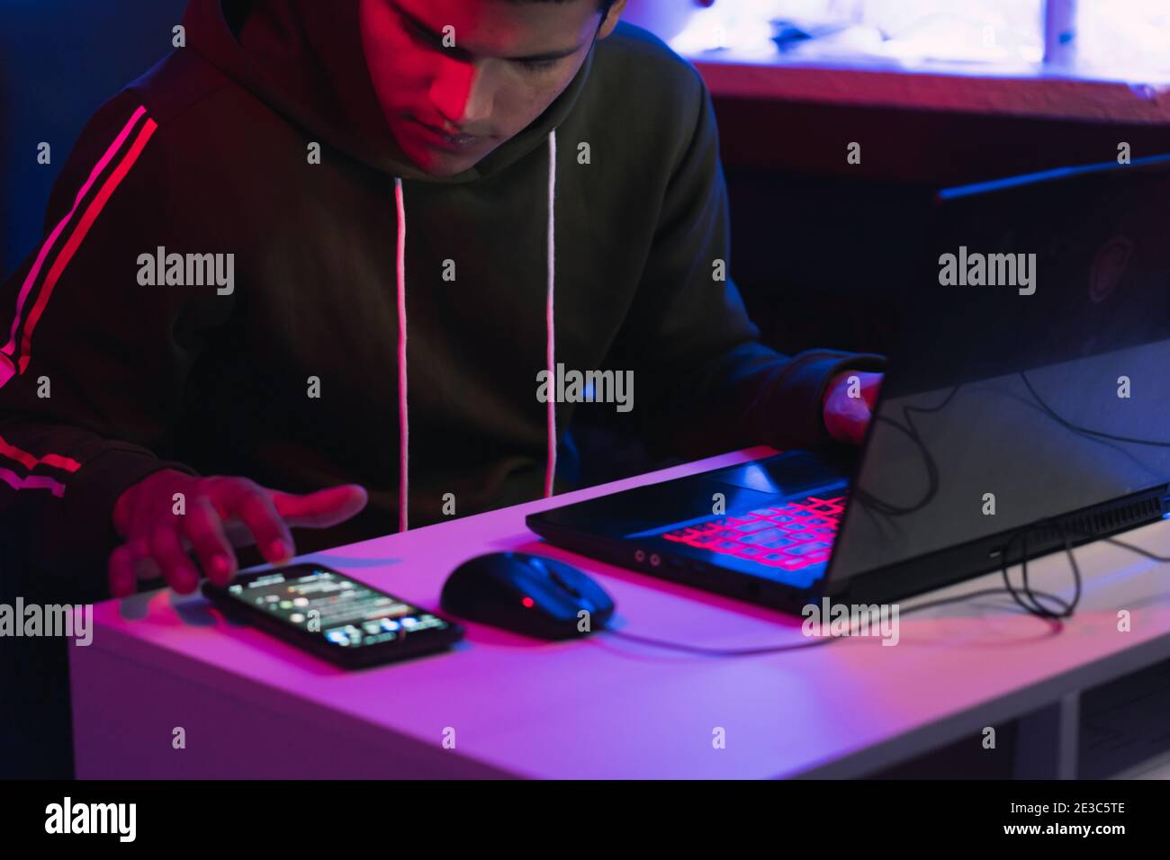 Young Hispanic male gamer doing a live video game streaming on his ...